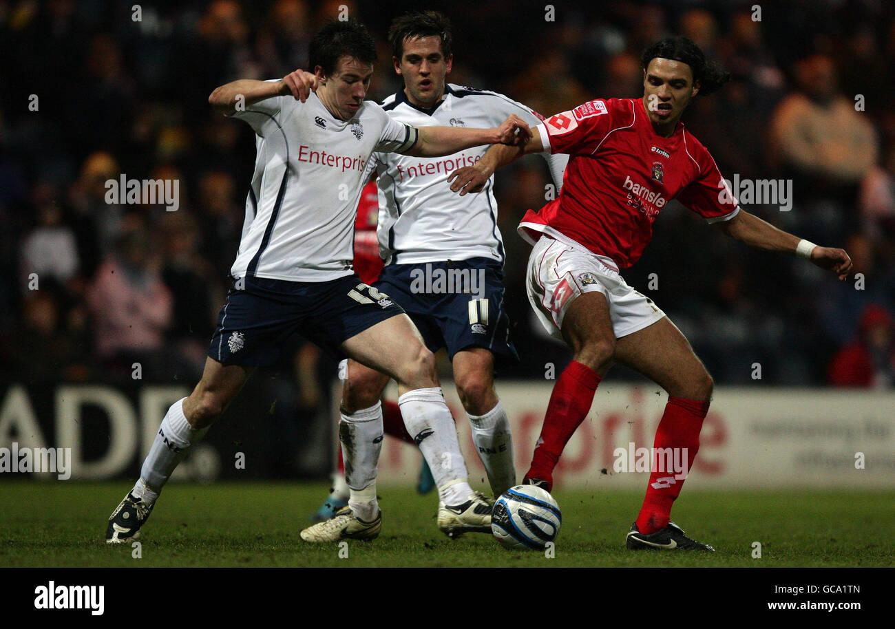Preston's Sean St Ledger (left) and Darren Carter (centre) challenge ...