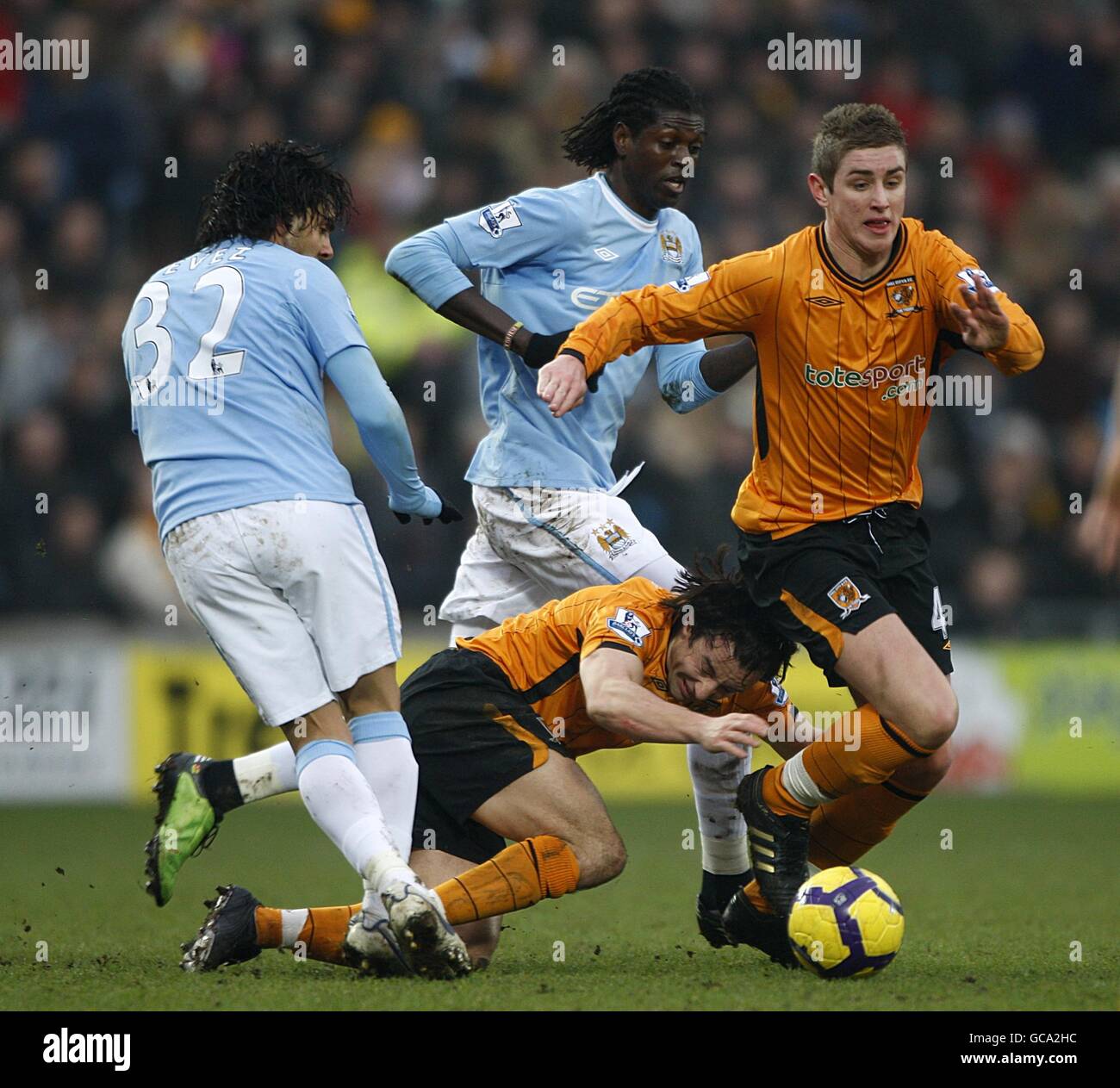 Hull City's Stephen Hunt (centre) goes to ground after a challenge by ...