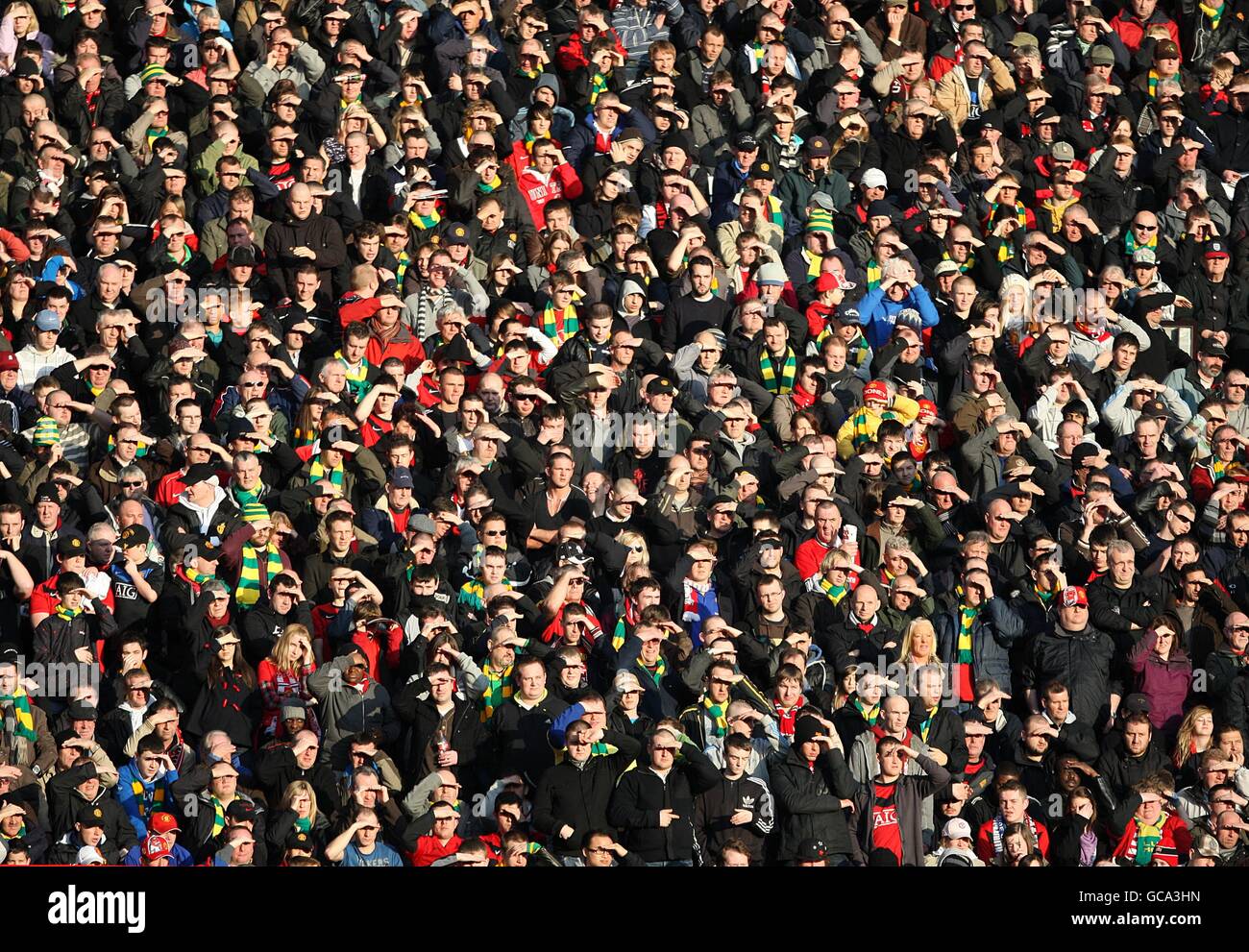 Manchester united fans shield their eyes from the sun hi-res stock ...