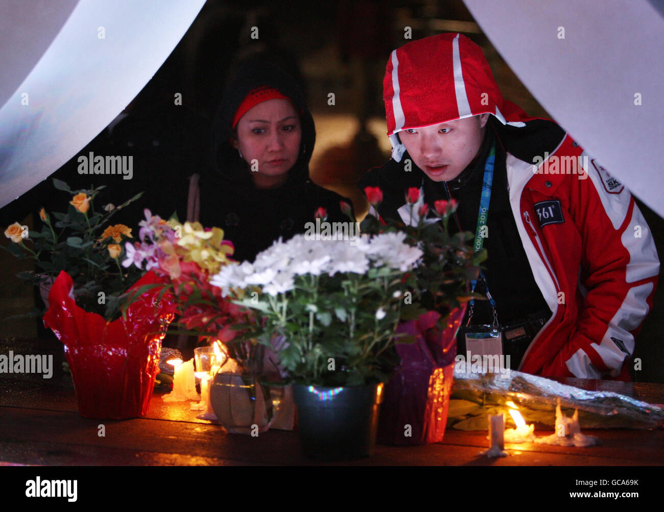 Members of the public look at the makeshift memorial to Georgian ...