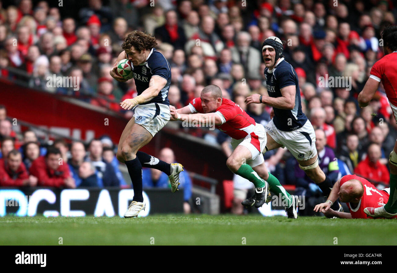 Scotland's Rory Lawson tries to break clear of Wales's Richie Rees ...