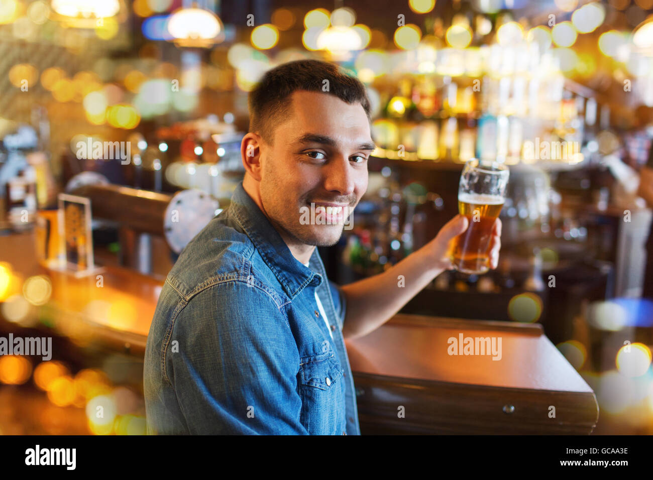 happy man drinking beer at bar or pub Stock Photo - Alamy