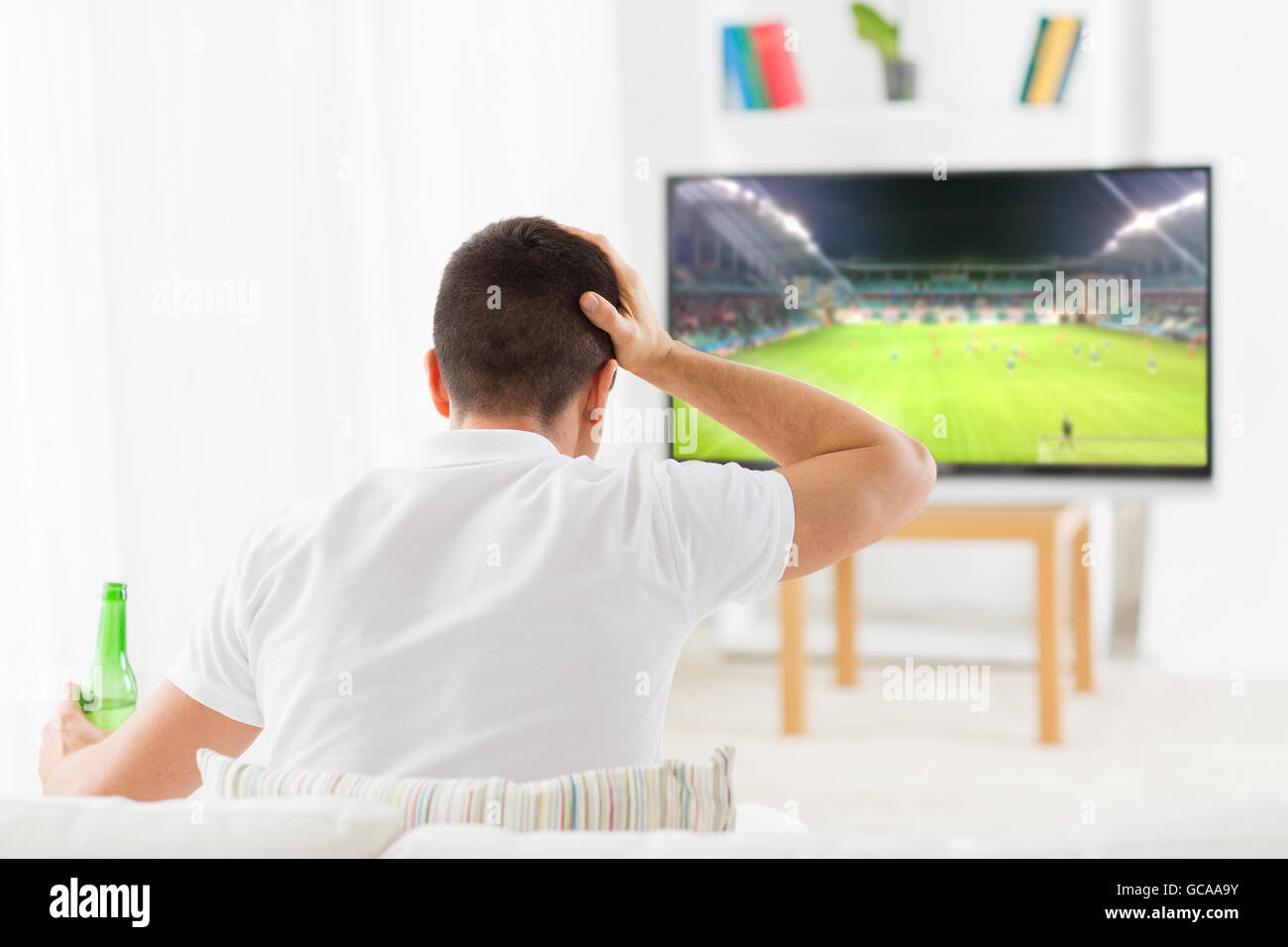 man watching football or soccer game on tv at home Stock Photo - Alamy