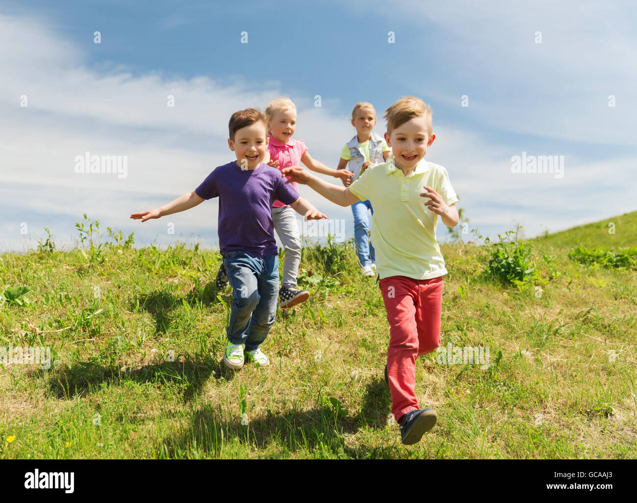 group of happy kids running outdoors Stock Photo - Alamy