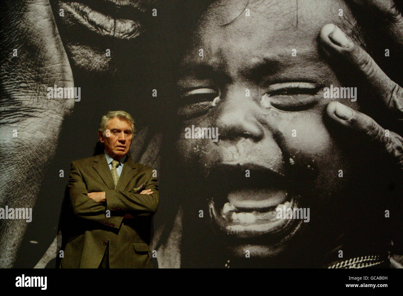 Photographer Don McCullin stands in front of one of his photographs on ...