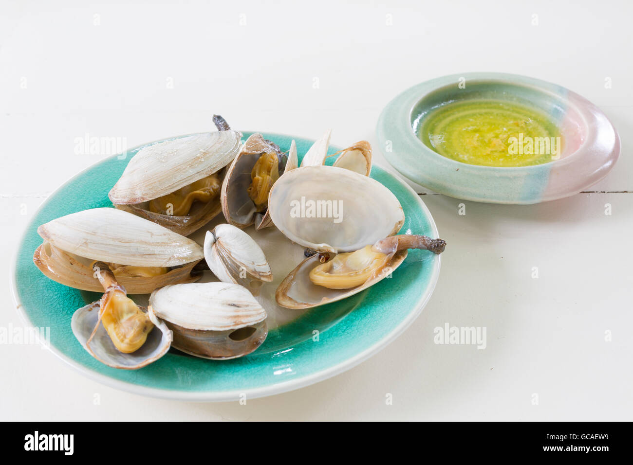 Cooked soft shell clams with melted butter Stock Photo - Alamy
