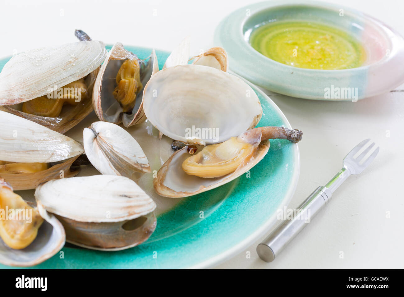 Cooked soft shell clams with melted butter Stock Photo - Alamy