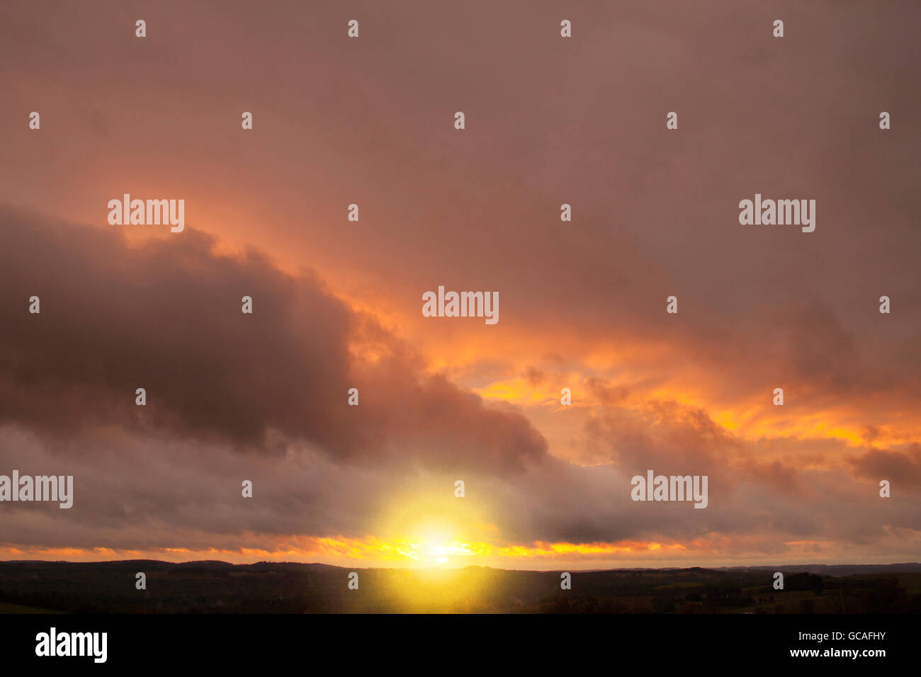 STORM CLOUDS AT SUNSET OVER FLAT LAND HORIZON Stock Photo - Alamy