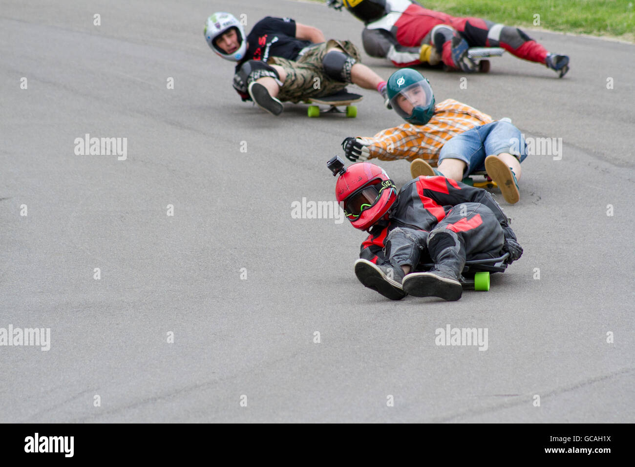 Racing downhill skateboarders laying on their boards (buckboarding ...