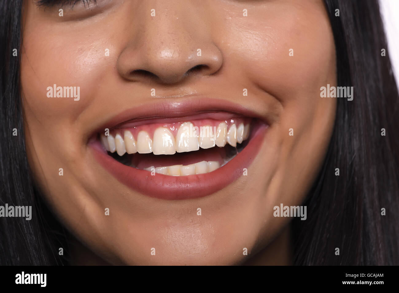 Close up of young beautiful woman with white healthy teeth smiling ...