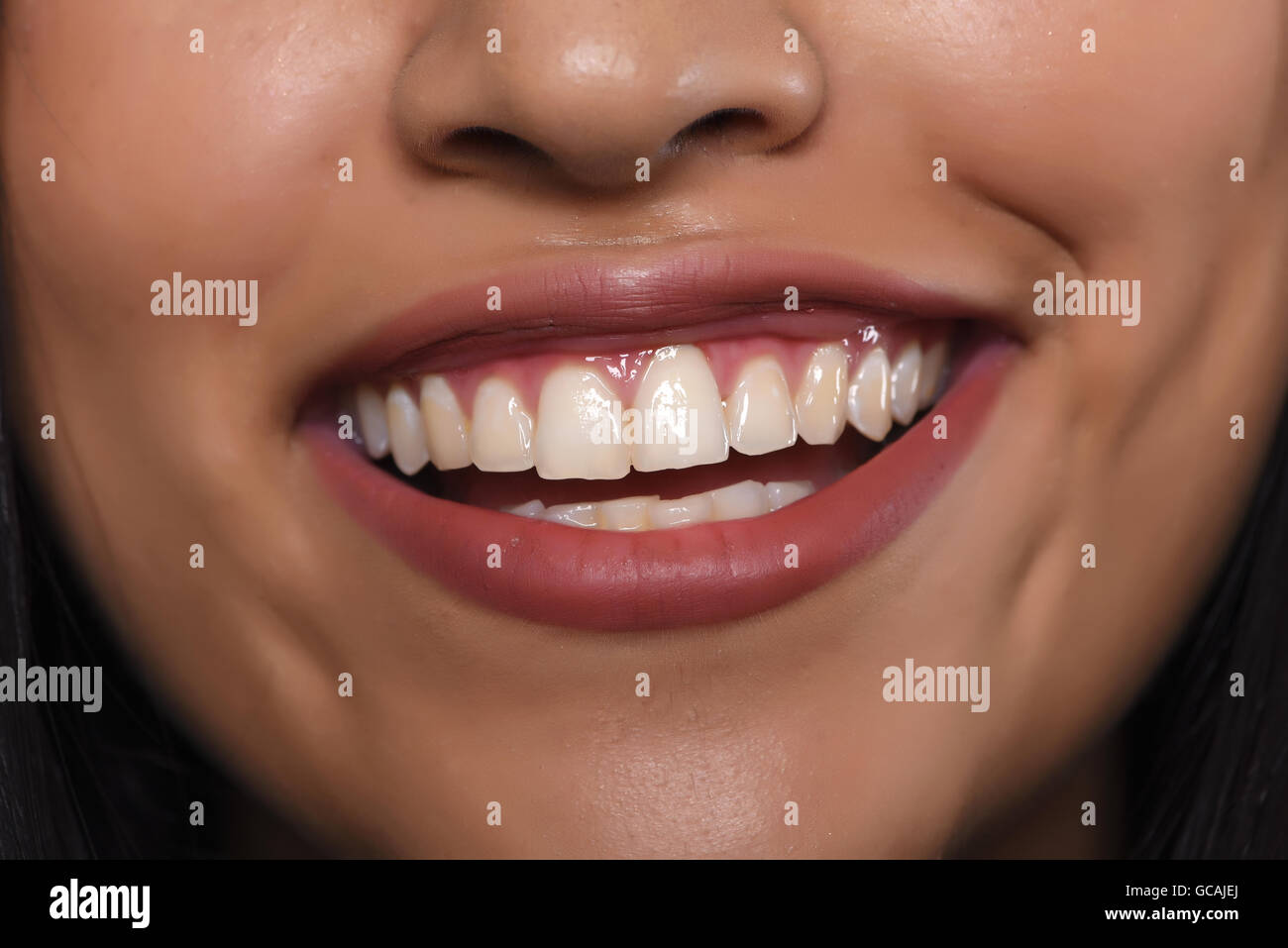 Close up of young beautiful woman with white healthy teeth smiling ...