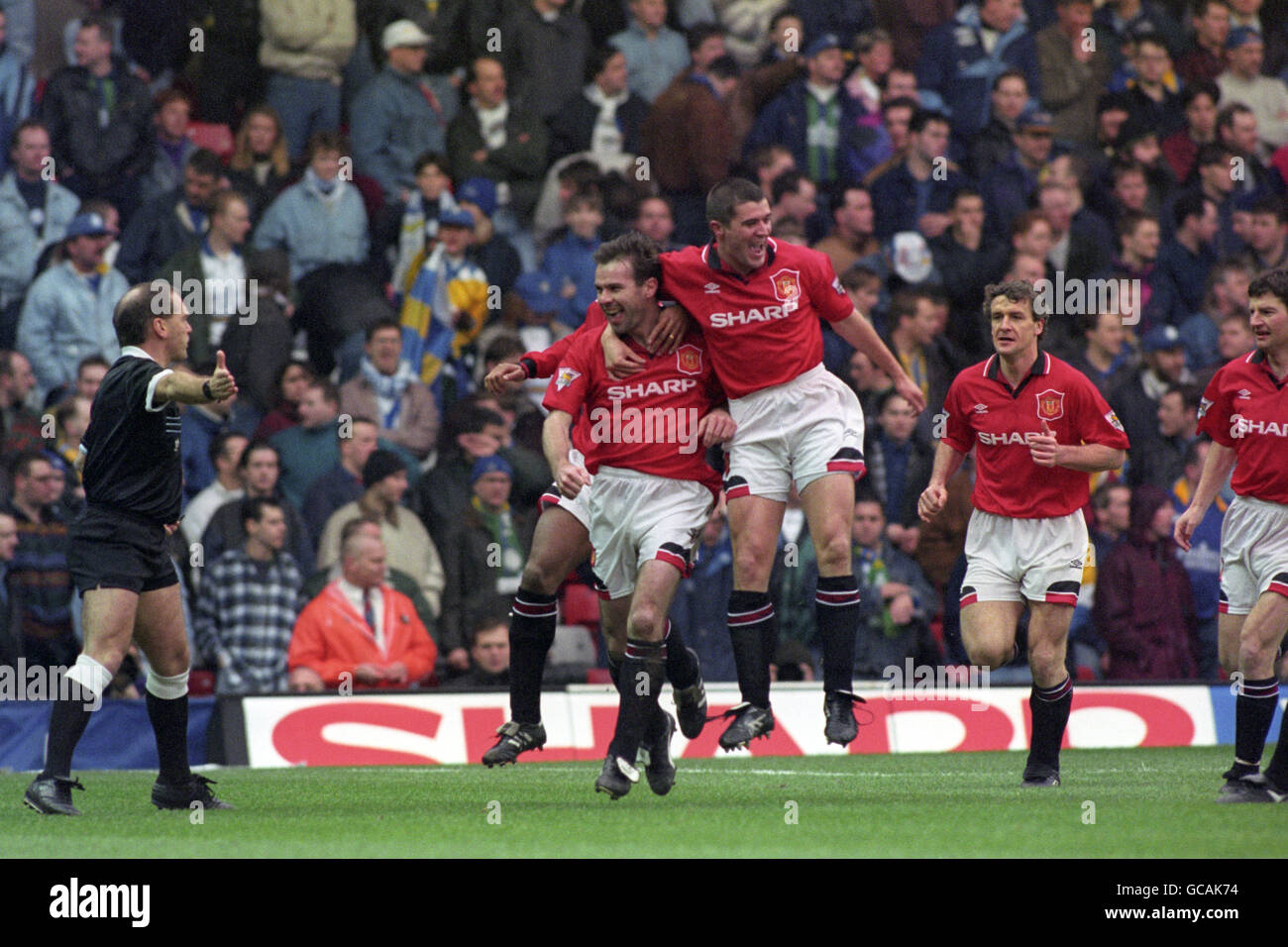 BRIAN MCLAIR (L) IS CONGRATULATED BY TEAMMATE ROY KEANE AFTER SCORING ...