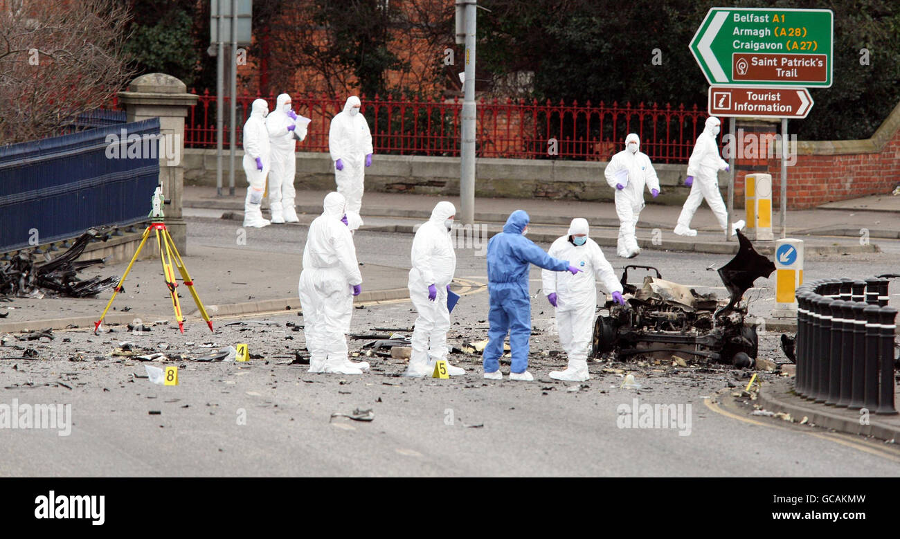 Police forensic experts at the scene of a car bomb attack outside Newry ...