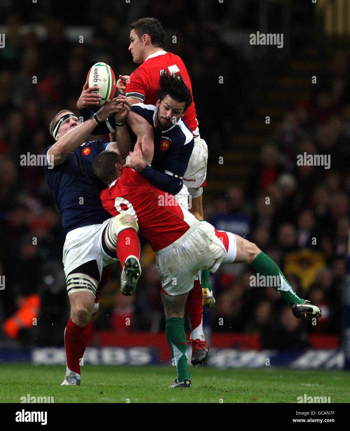 Wales' Lee Byrne and Richie Rees and France's Clement Poitrenaud and ...