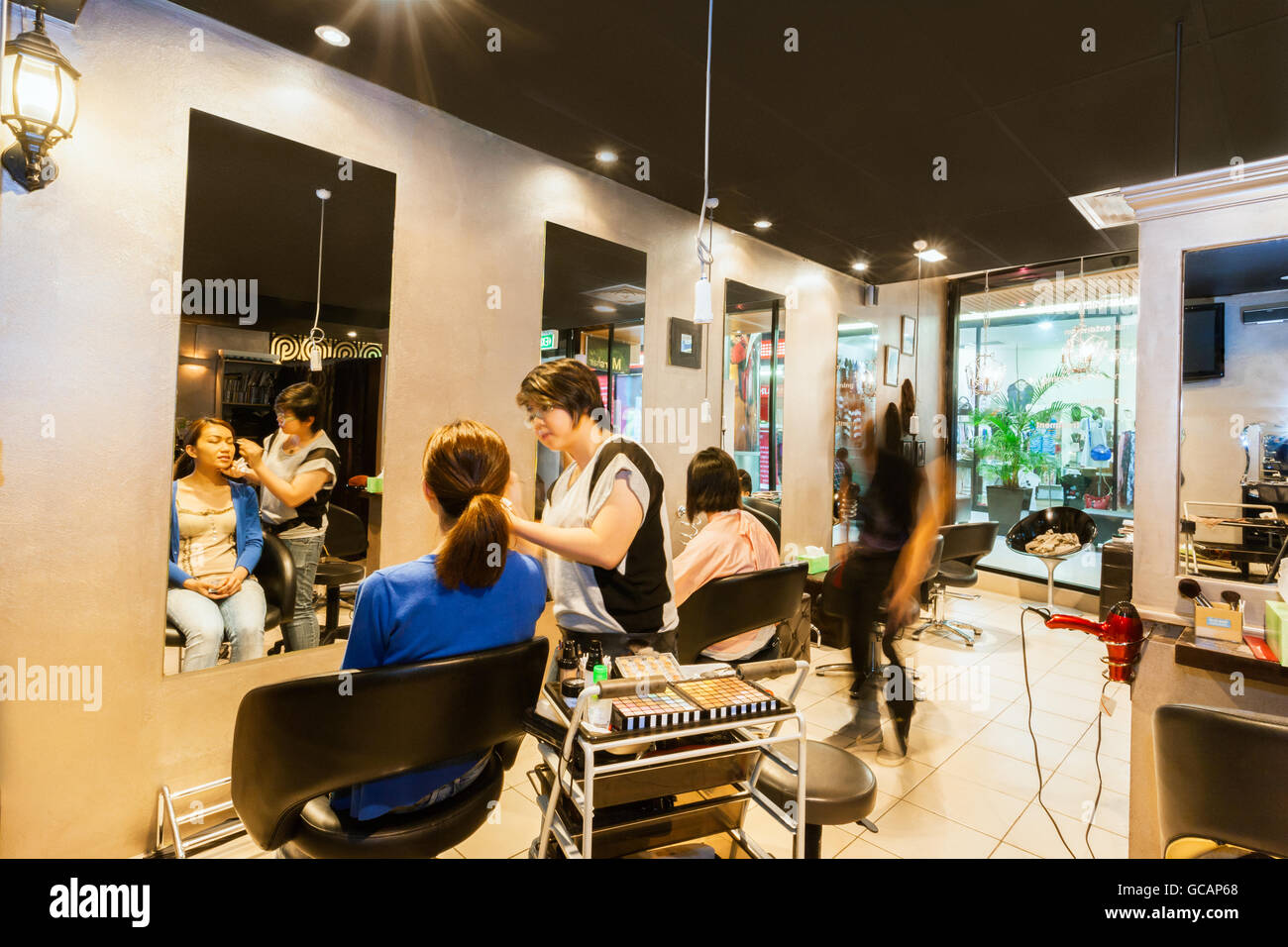 Beauty salon with lady customers having treatments in front of the ...