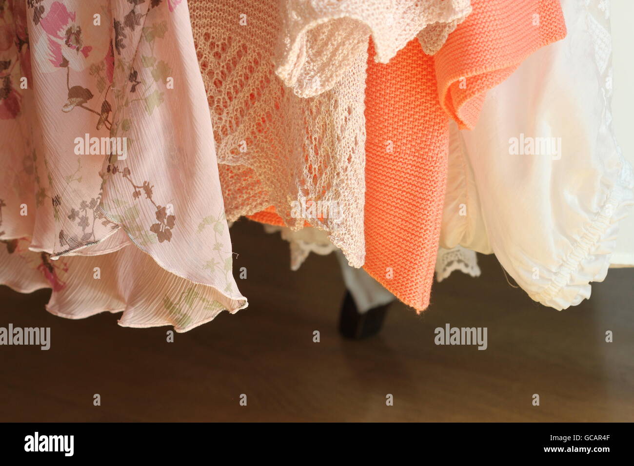 collection of women's clothes hanging on a rack Stock Photo - Alamy