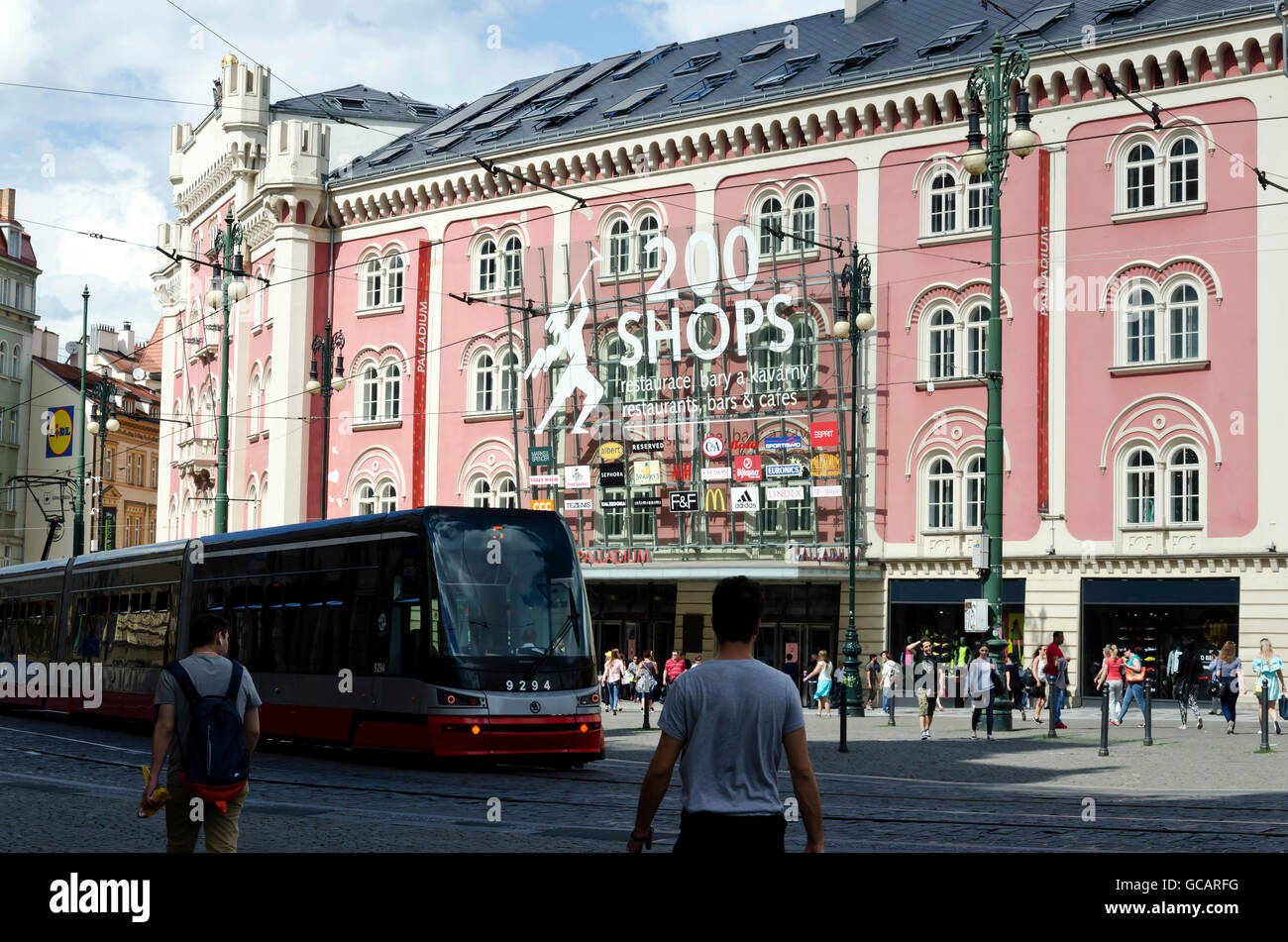 A modern tram passes a large, modern shopping mall in the centre of ...