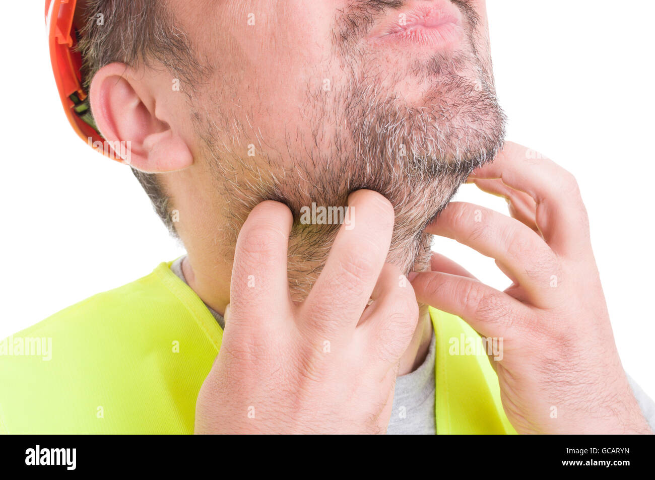 Closeup of male builder scratching his beard with both hands as ...