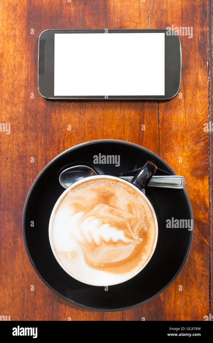 Up view of coffee and smartphone with blank white screen or display ...
