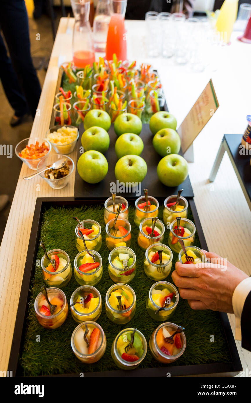 Hand picking fresh cut fruit from a healthy buffet Stock Photo - Alamy