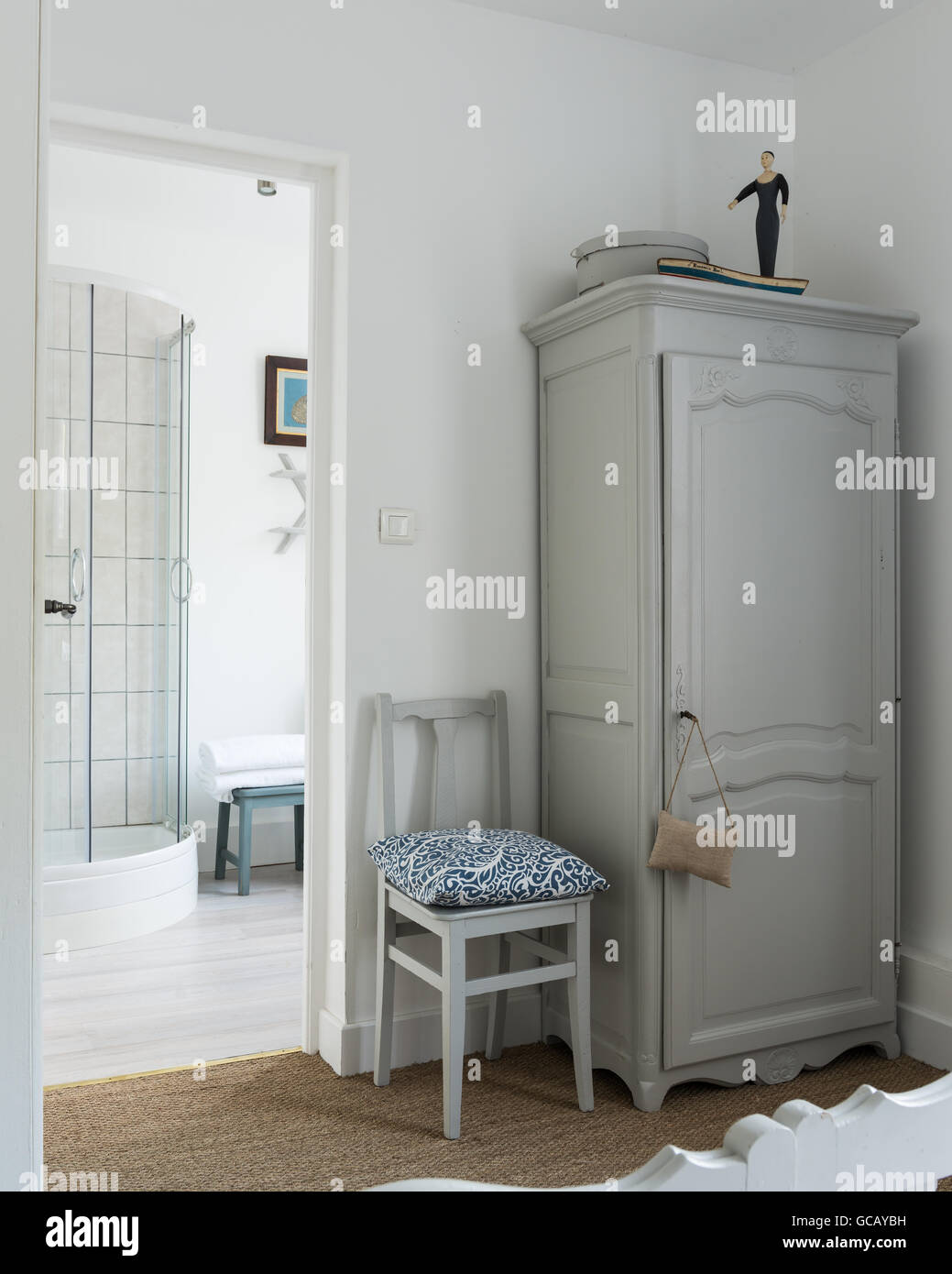 French cupboard in corner of guest room with view through to white ...