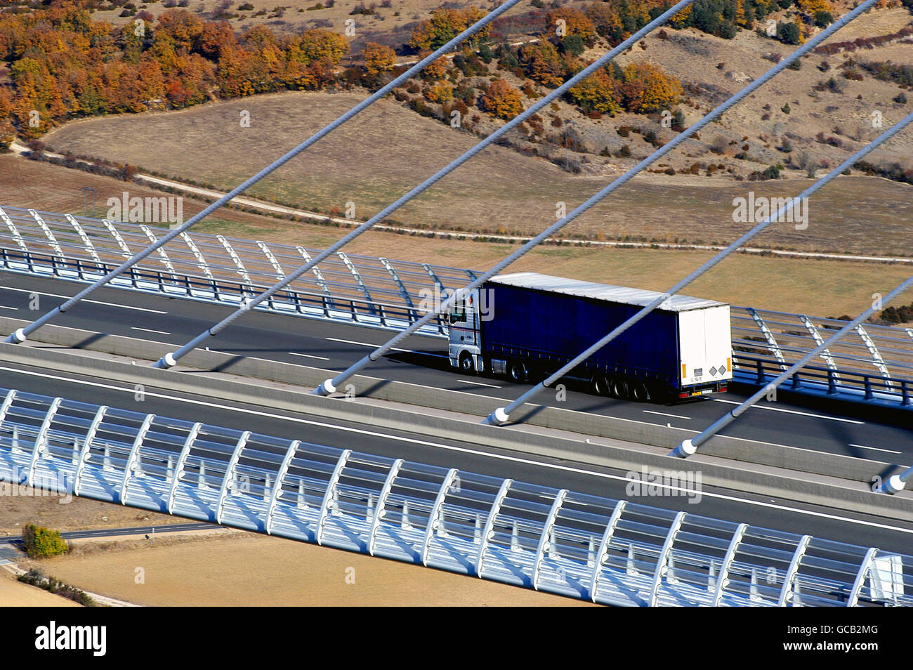 truck traveling on the highway and passing a high viaduct which ...