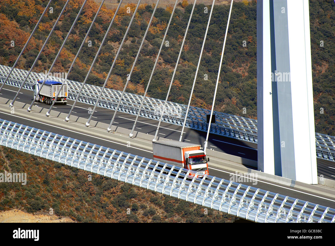 truck traveling on the highway and passing a high viaduct which ...