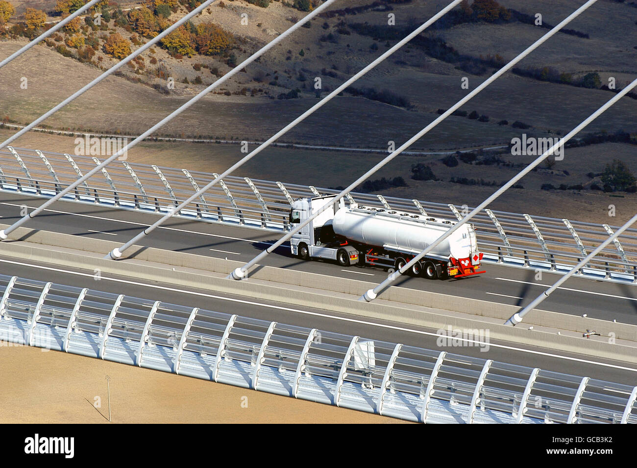 truck traveling on the highway and passing a high viaduct which ...
