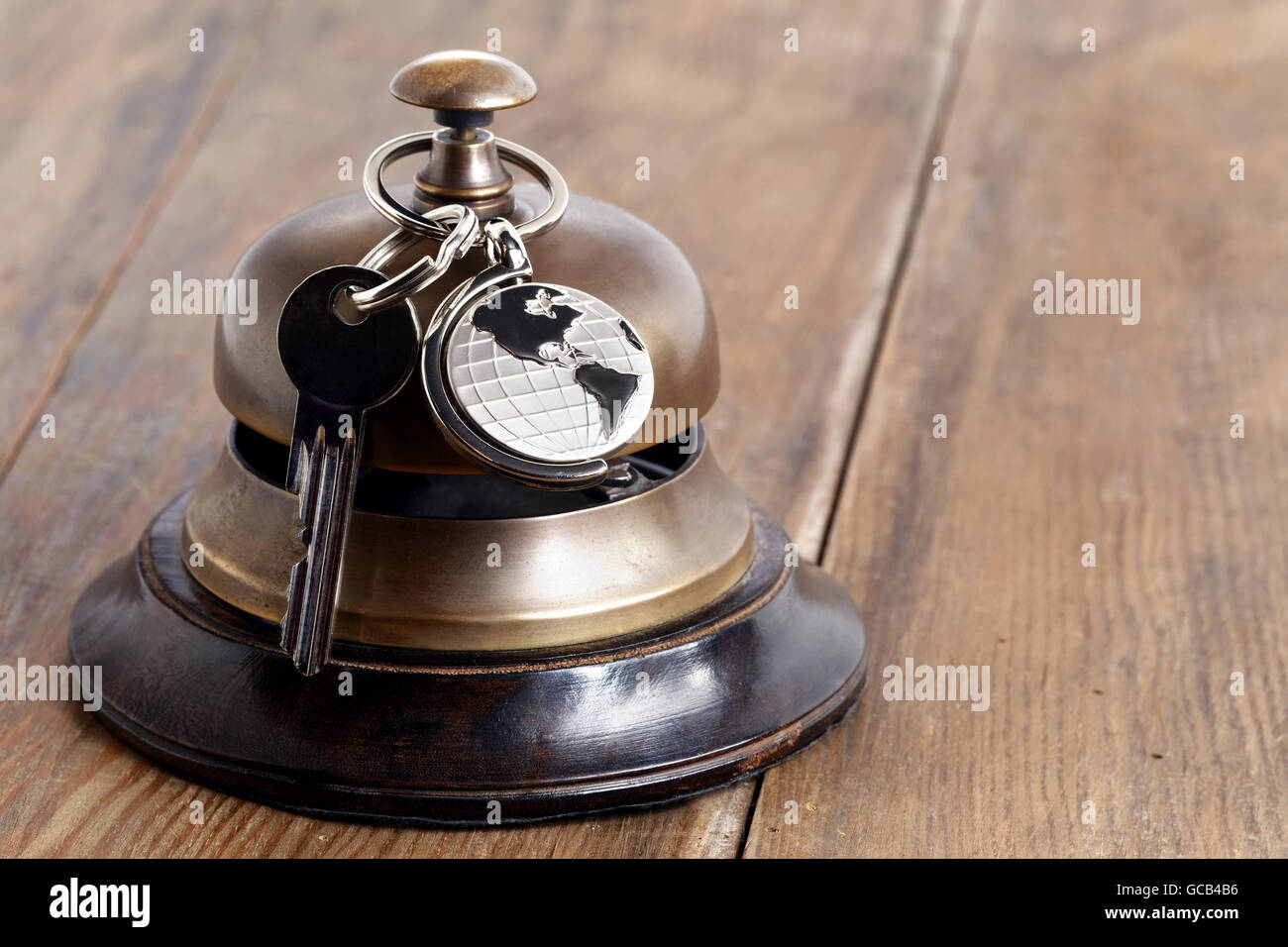 Reception bell and hotel key on a reception desk Stock Photo - Alamy