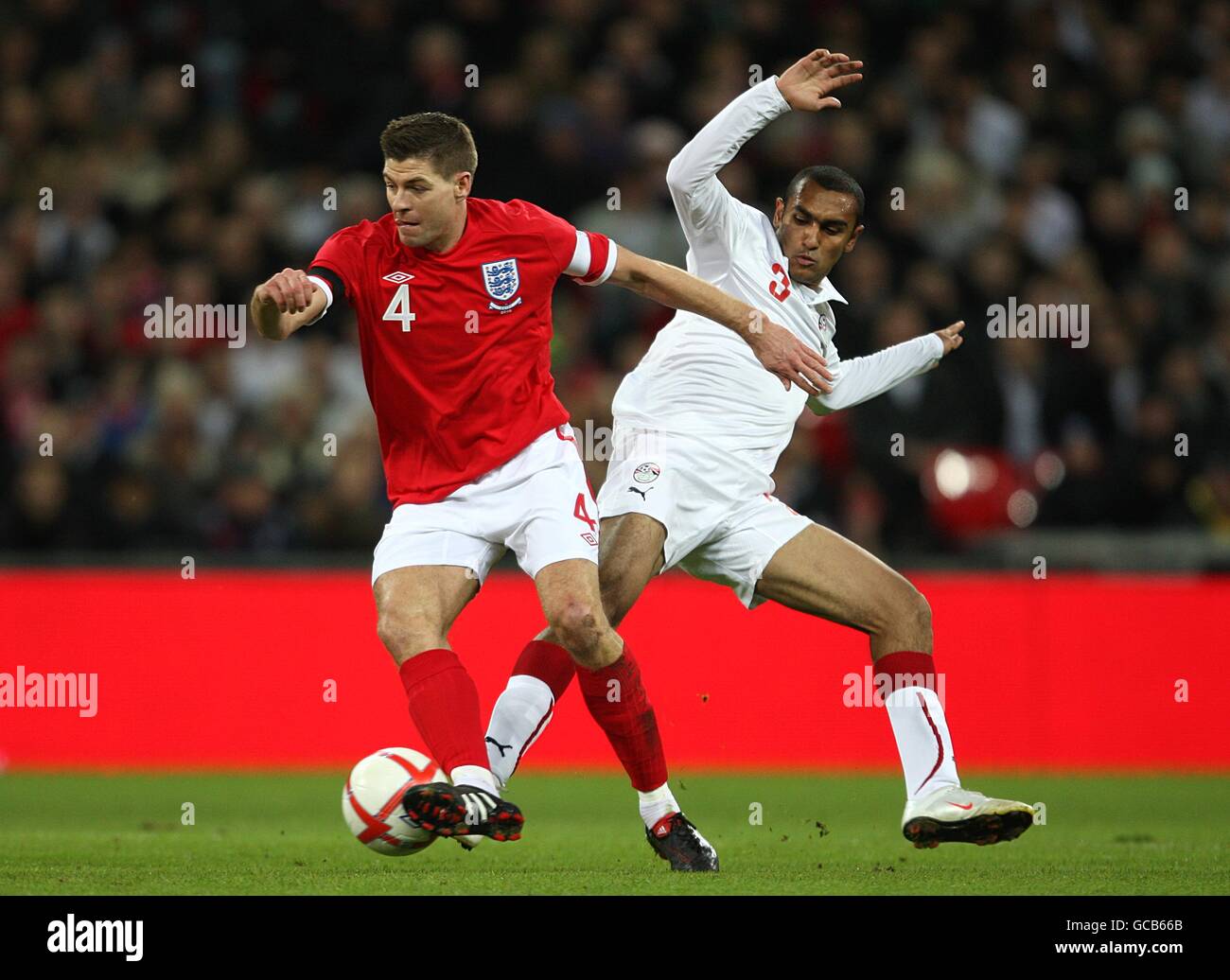 England's Steven Gerrard (left) and Egypt's Ahmed Al-Muhammadi battle ...