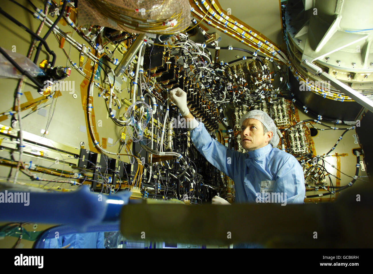 Wiring engineer Steve Alderton works inside a KA band satellite at ...