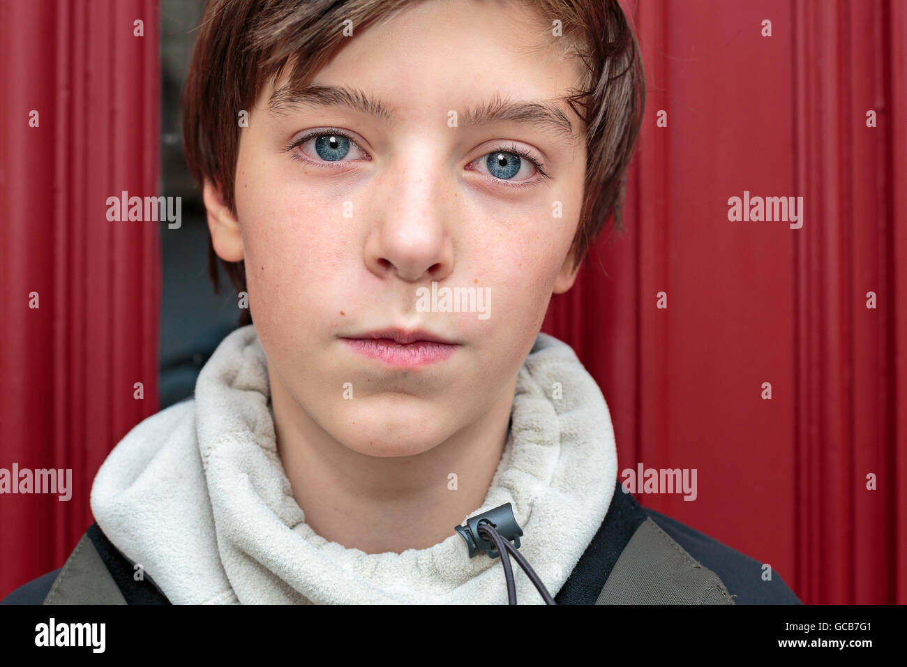 portrait of a teenage boy with red background Stock Photo - Alamy