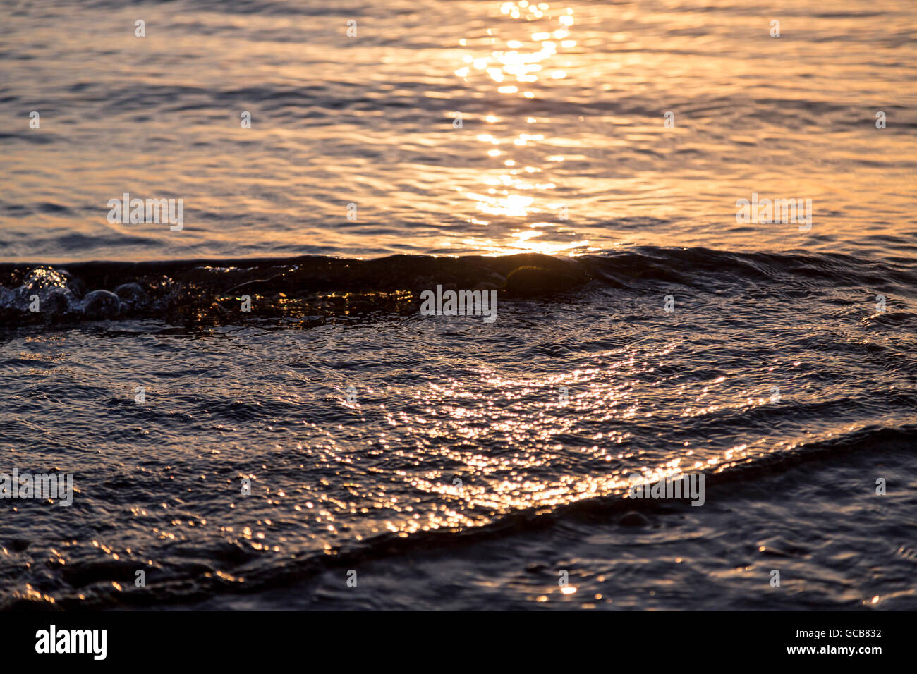ocean ripples at the sunset for backgrounds Stock Photo - Alamy