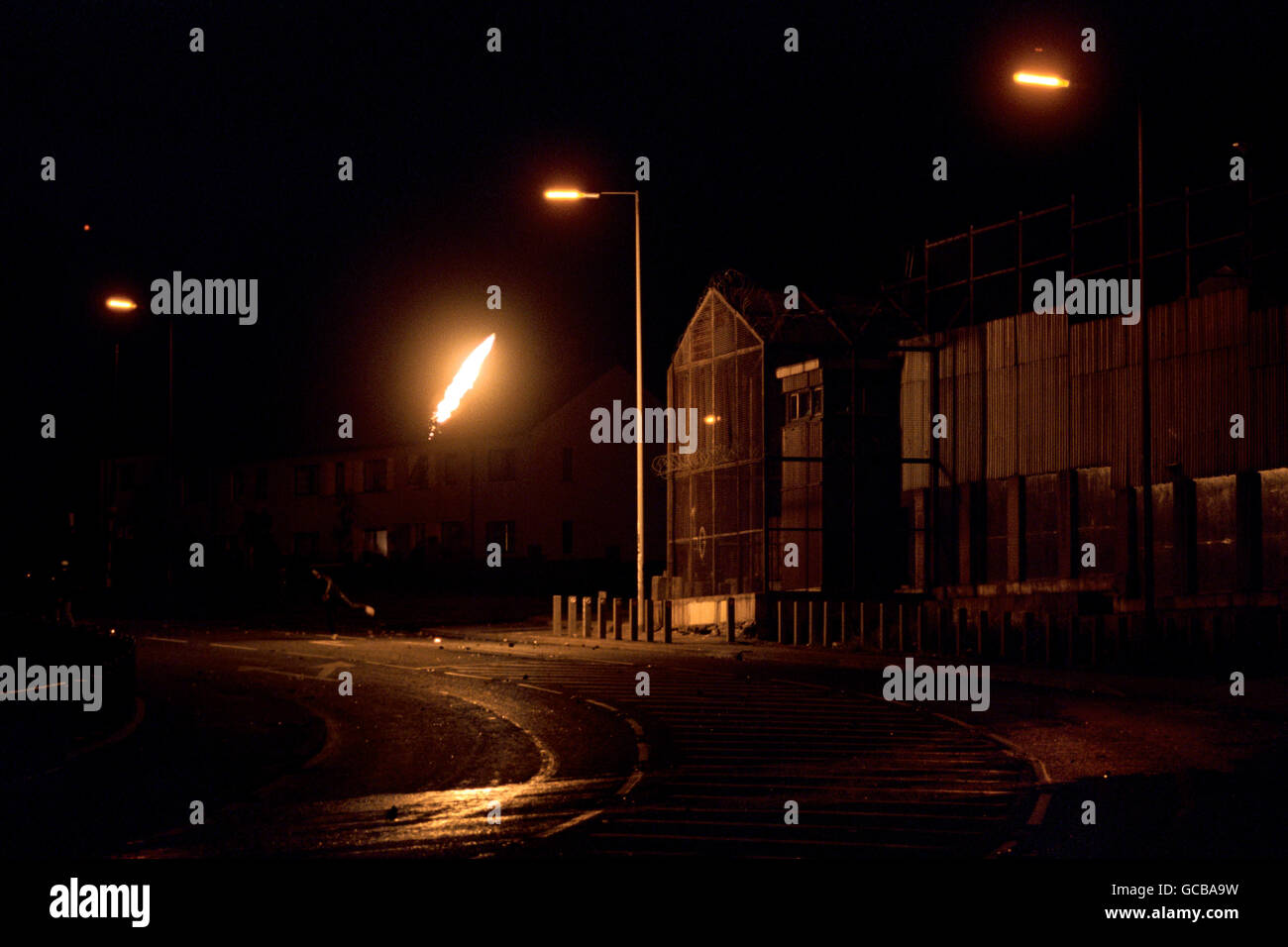 A PETROLBOMBER HURLS A DEVICE AT A POLICE STATION DURING DISTURBANCES ...