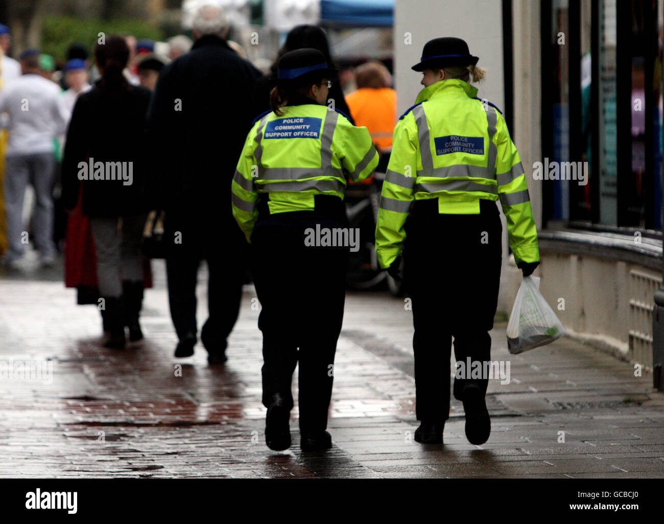 Police Community Support Officers walk along a street in Wallingford ...