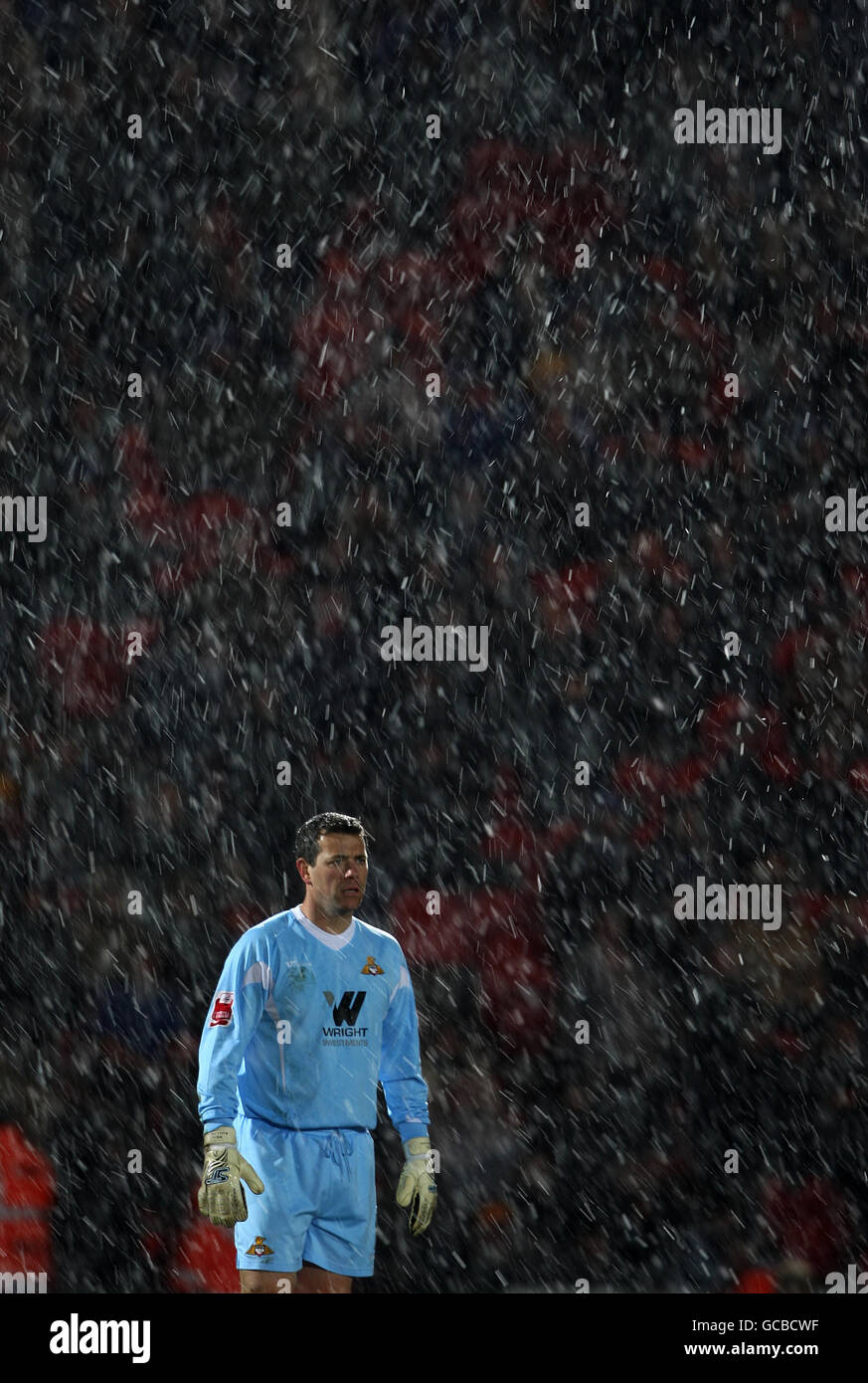 Doncaster Rovers' goalkeeper Neil Sullivan stands in a blizzard as the ...