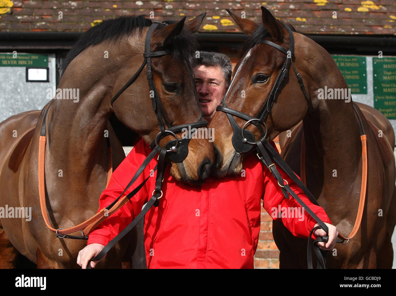 Trainer Paul Nicholls with Twist Magic (left) and Masterminded during ...