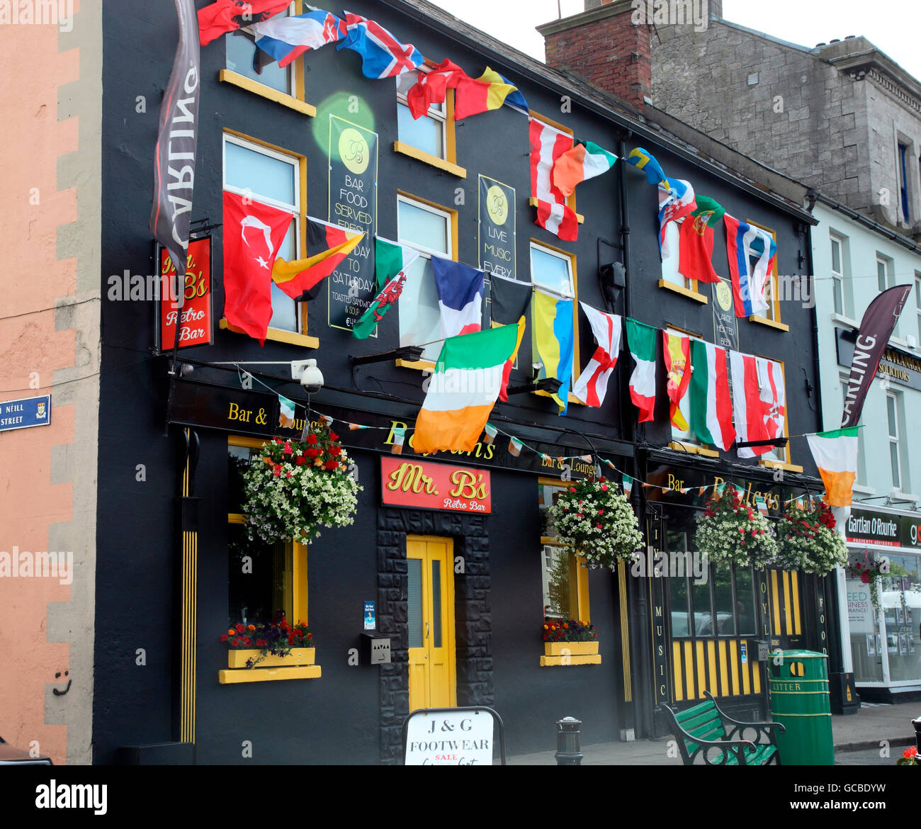 Flags flying outside Boylan's Bar, Carrickmacross Stock Photo - Alamy