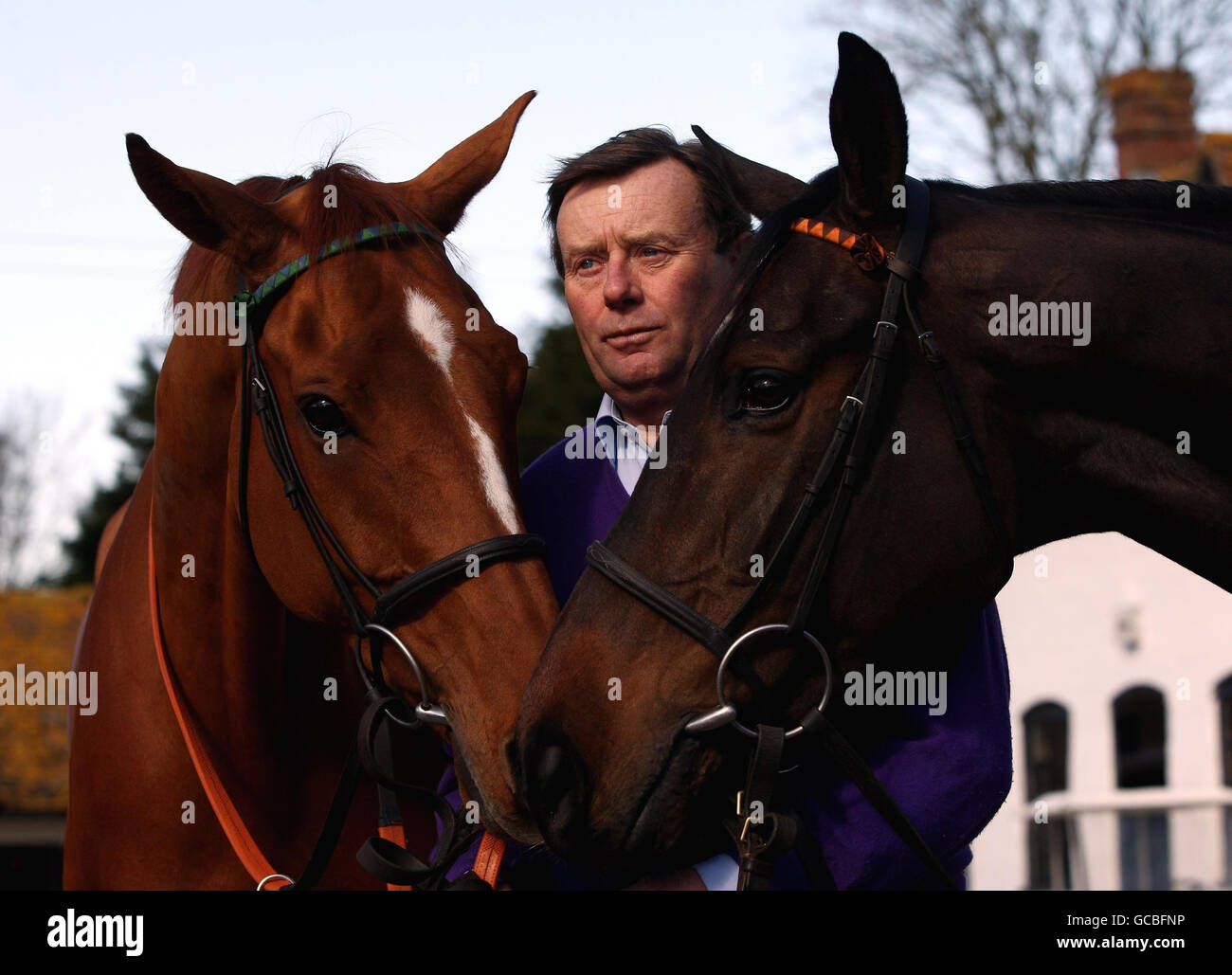 Trainer Nicky Henderson with Punchestowns (left) and Long Run (right ...