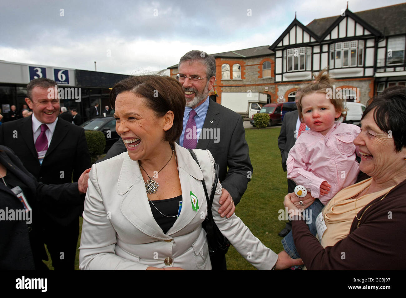 Mary Lou McDonald and Gerry Adams (centre) meet little Aine Sargent and ...