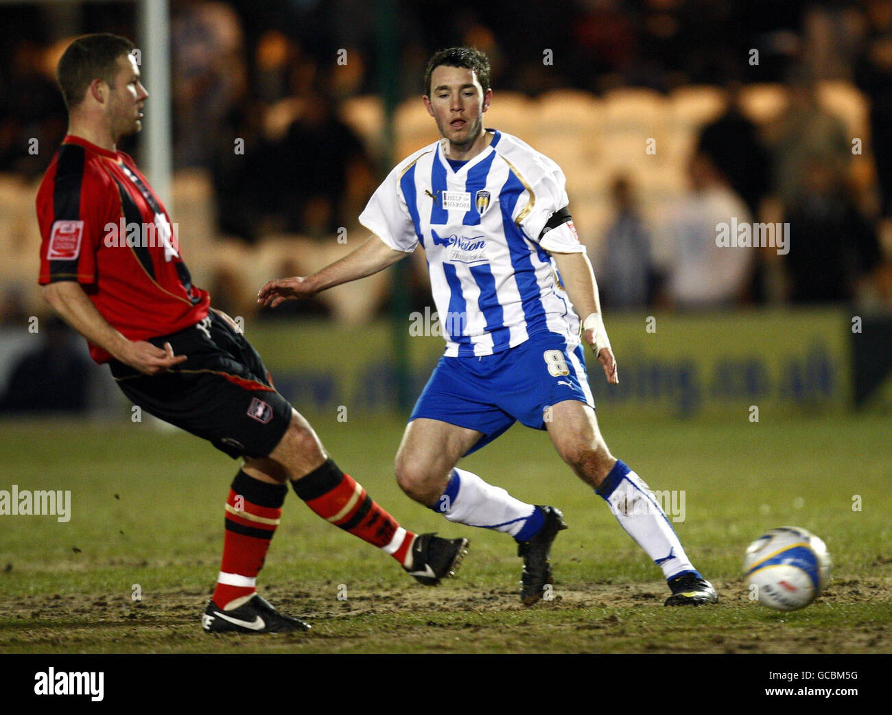 Brighton's Alan Navarro (left) and Colchester's John-Joe O.Toole battle ...