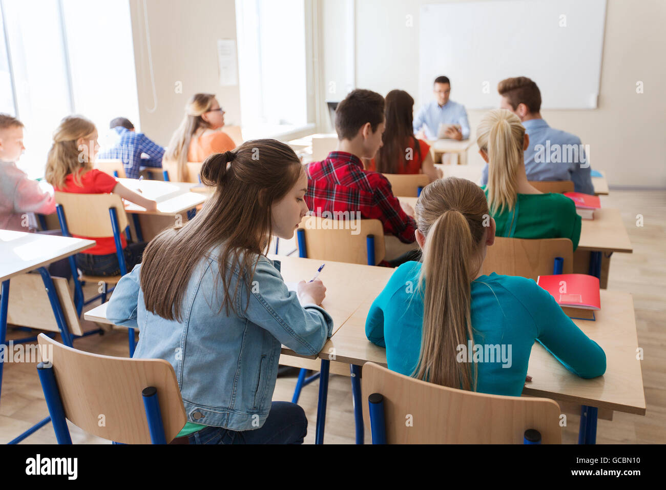 group of students writing school test Stock Photo - Alamy