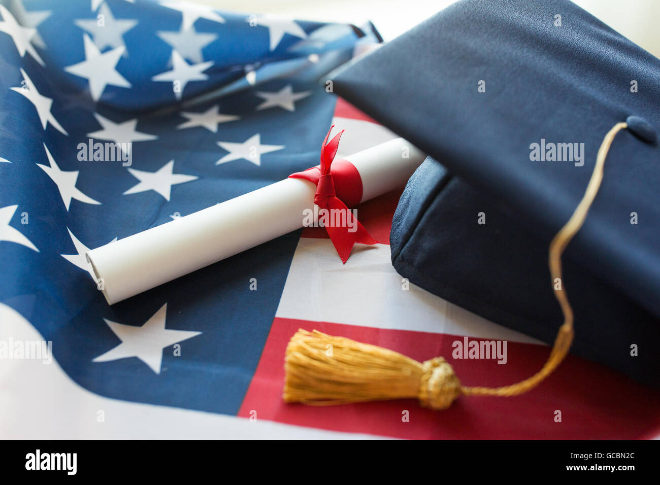bachelor hat and diploma on american flag Stock Photo - Alamy