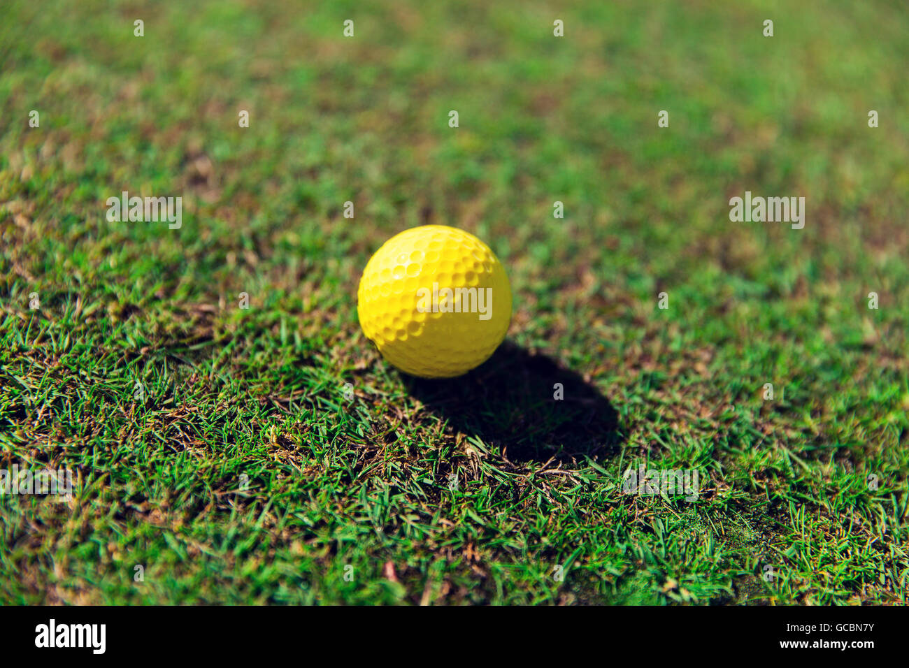 Yellow golf ball on tee hi-res stock photography and images - Alamy