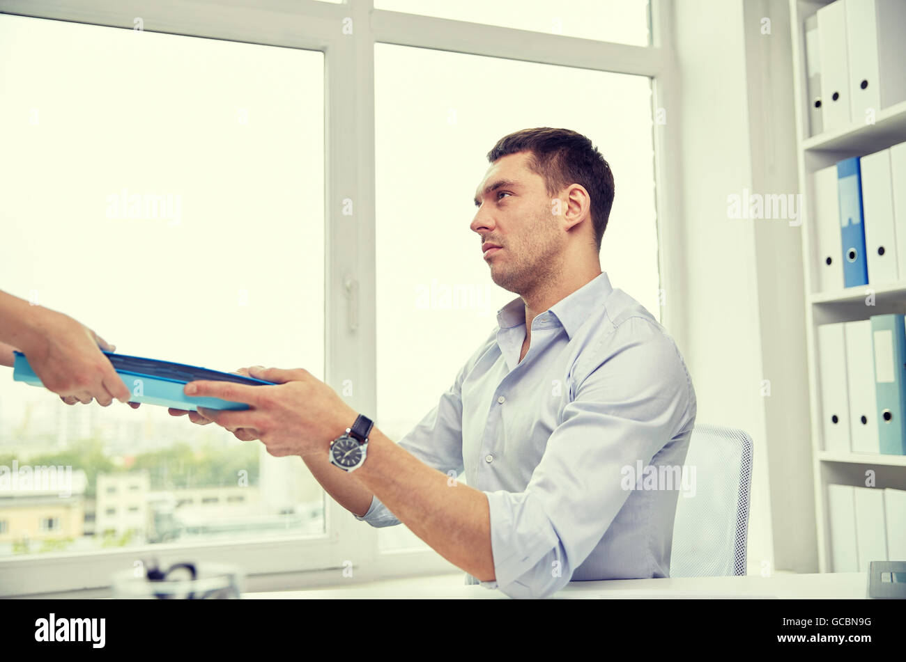 businessman taking papers from secretary in office Stock Photo - Alamy