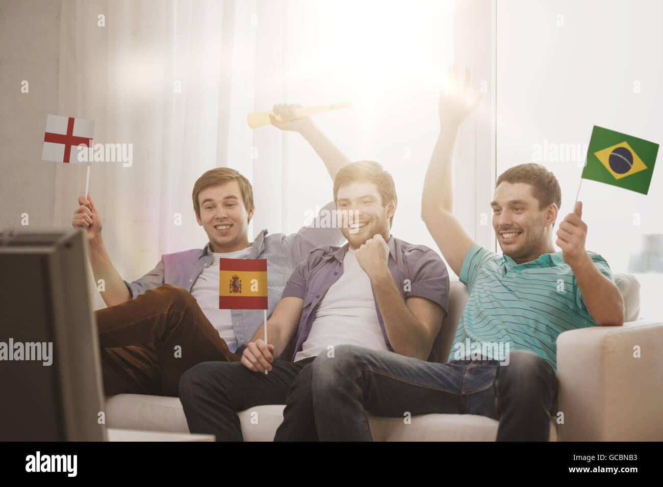 happy male friends with flags and vuvuzela Stock Photo - Alamy