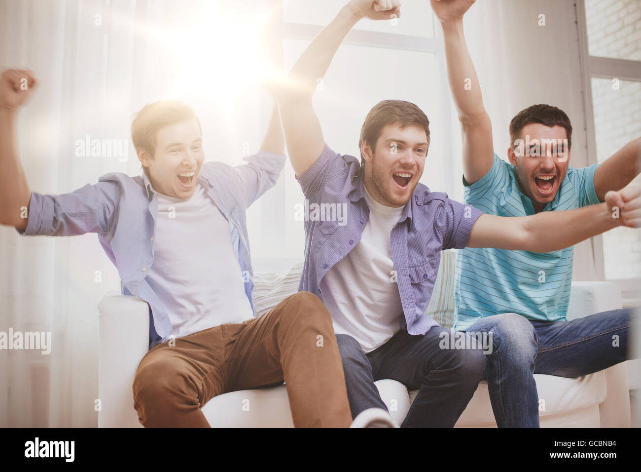 happy male friends at home Stock Photo - Alamy