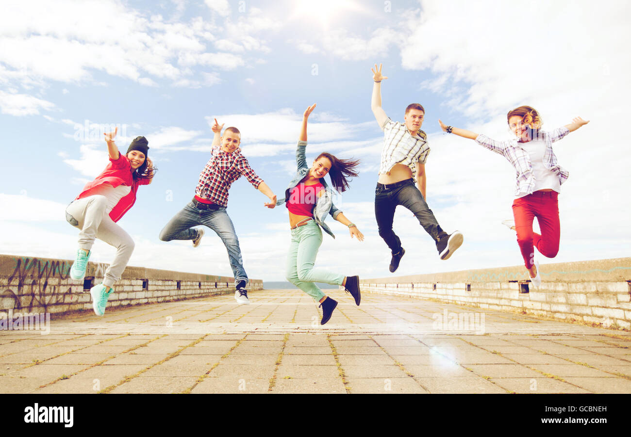 group of teenagers jumping Stock Photo - Alamy