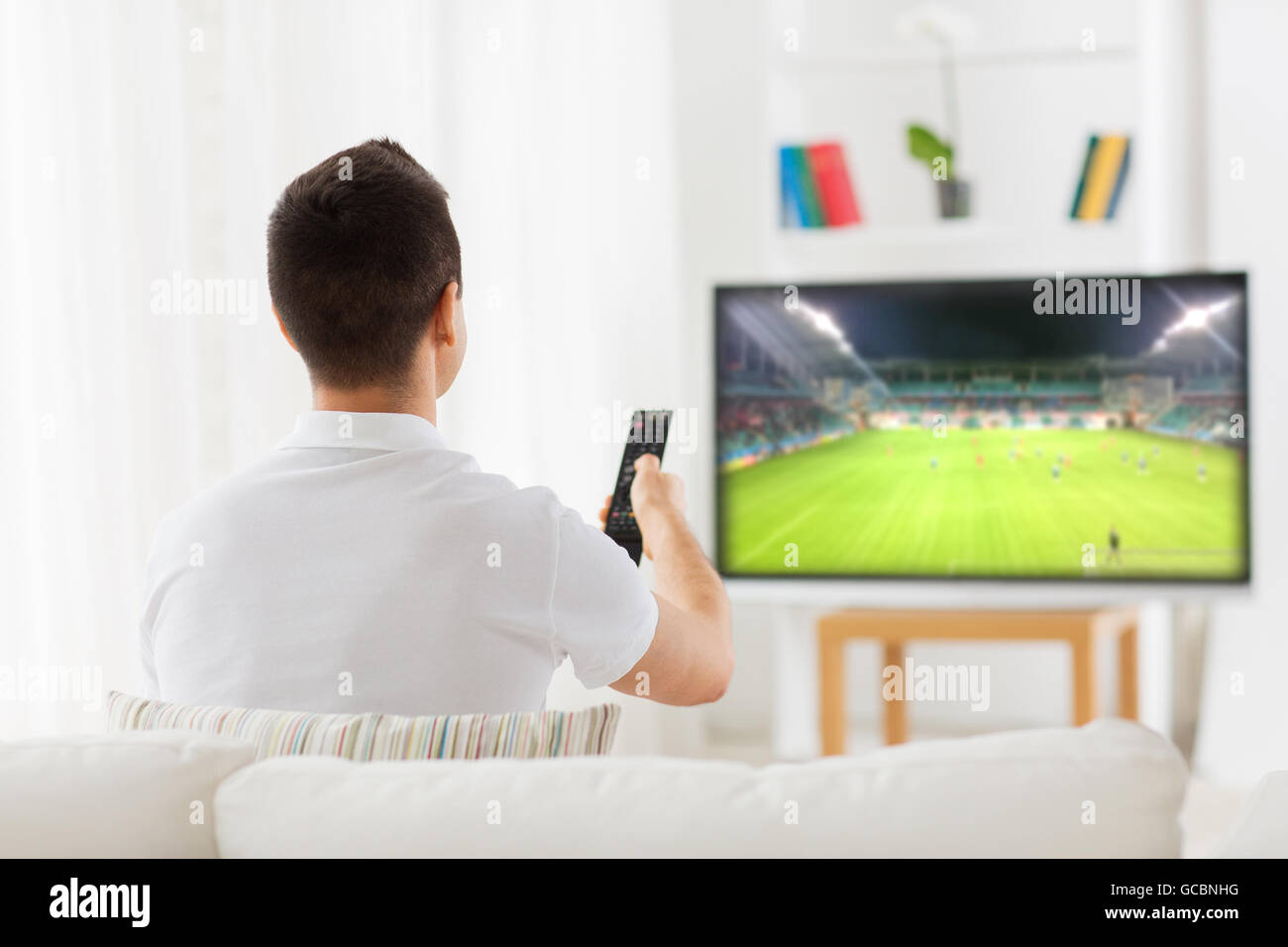 Man watching football on tv hi-res stock photography and images - Alamy