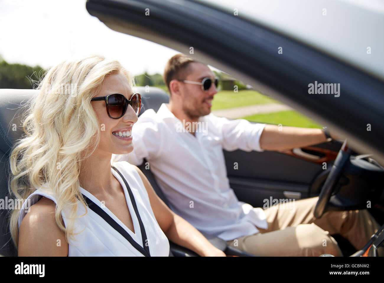 happy man and woman driving in cabriolet car Stock Photo - Alamy